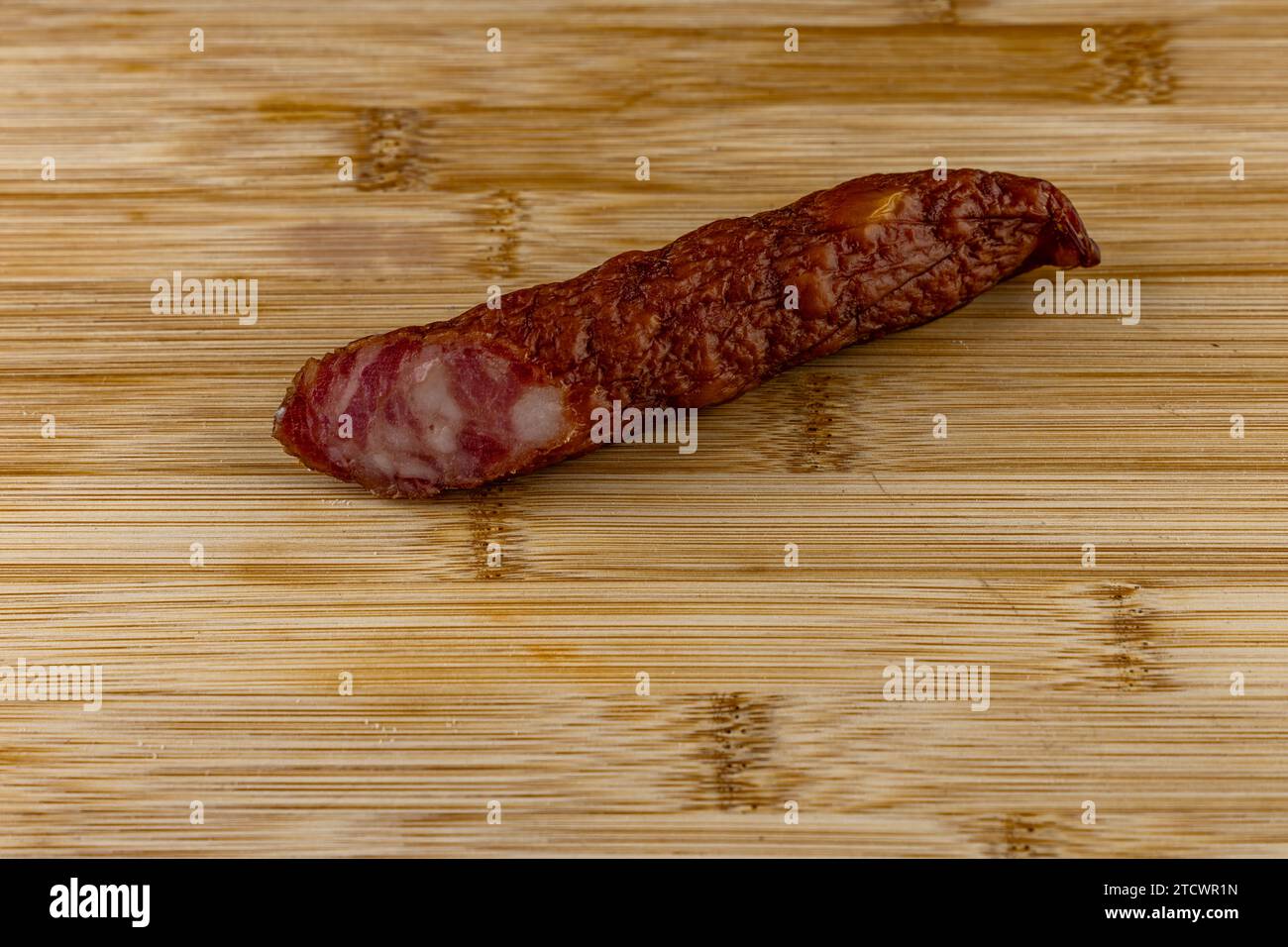 Long dried wild boar sausage on a wooden cutting board, healthy food ...