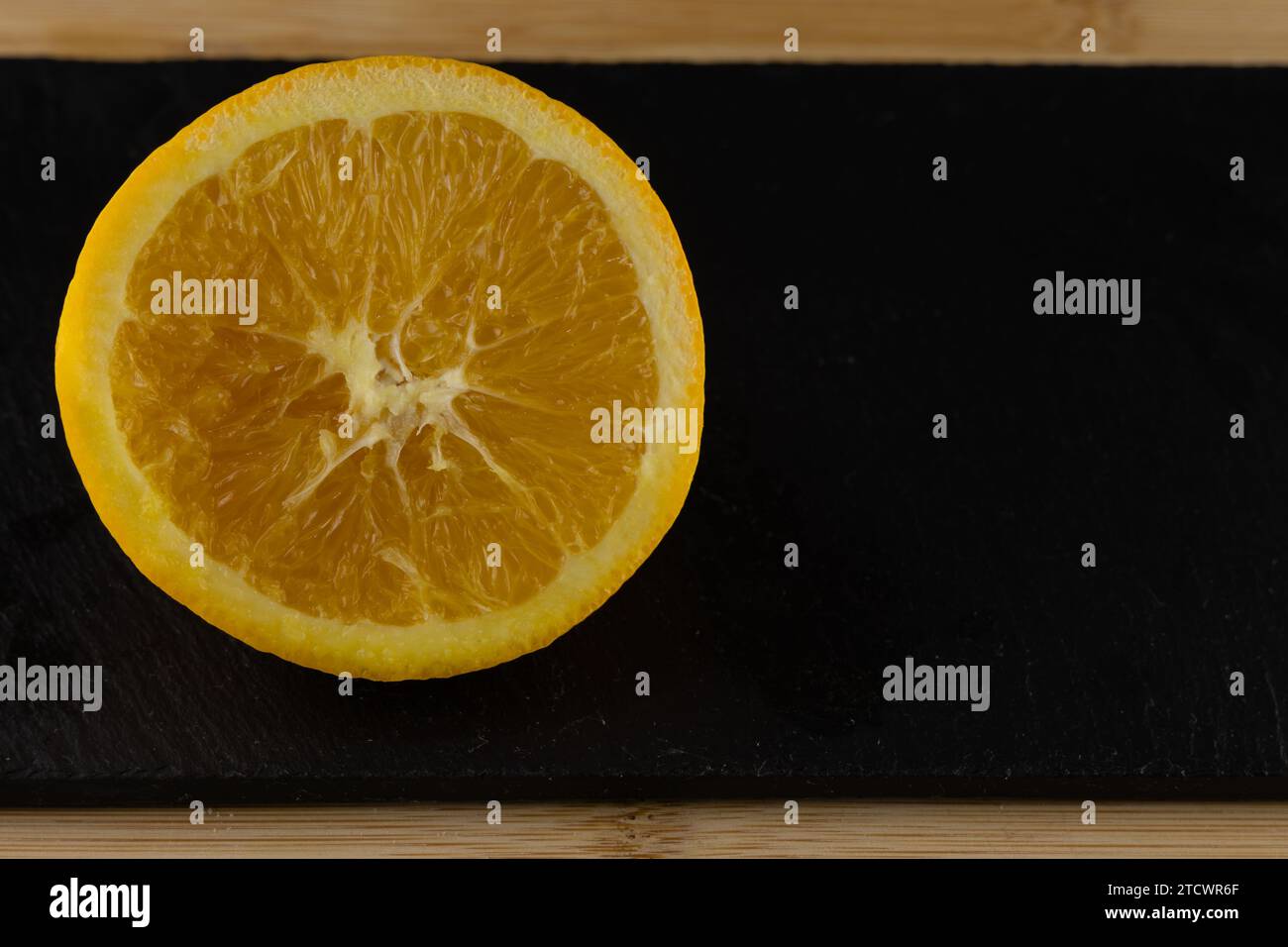 Yellow lemon cut in half on a stone slab, citrus fruits Stock Photo - Alamy