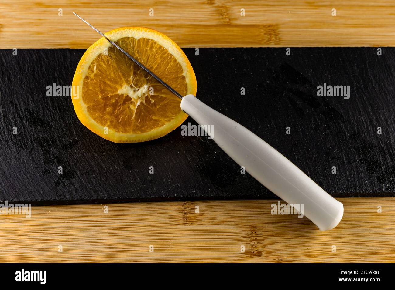Yellow lemon cut in half on a stone slab, citrus fruits Stock Photo - Alamy