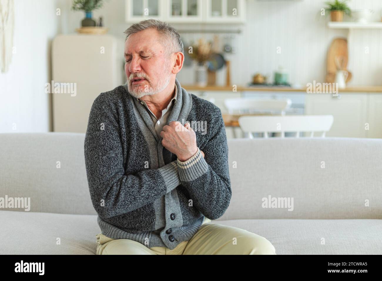Pain on heart, heart attack. Unhappy middle aged senior man suffering ...