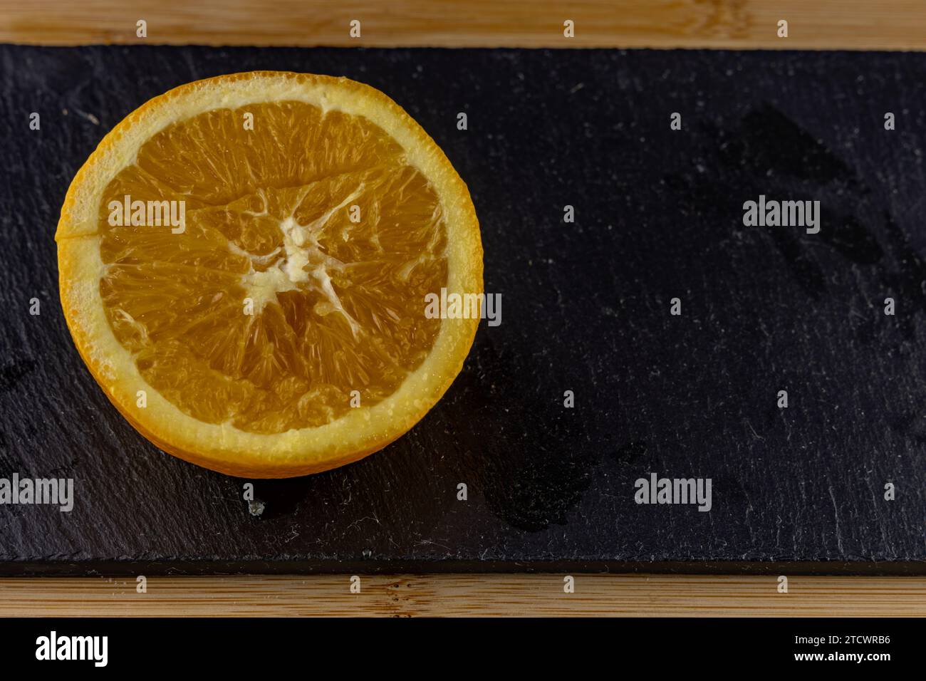 Yellow lemon cut in half on a stone slab, citrus fruits Stock Photo - Alamy