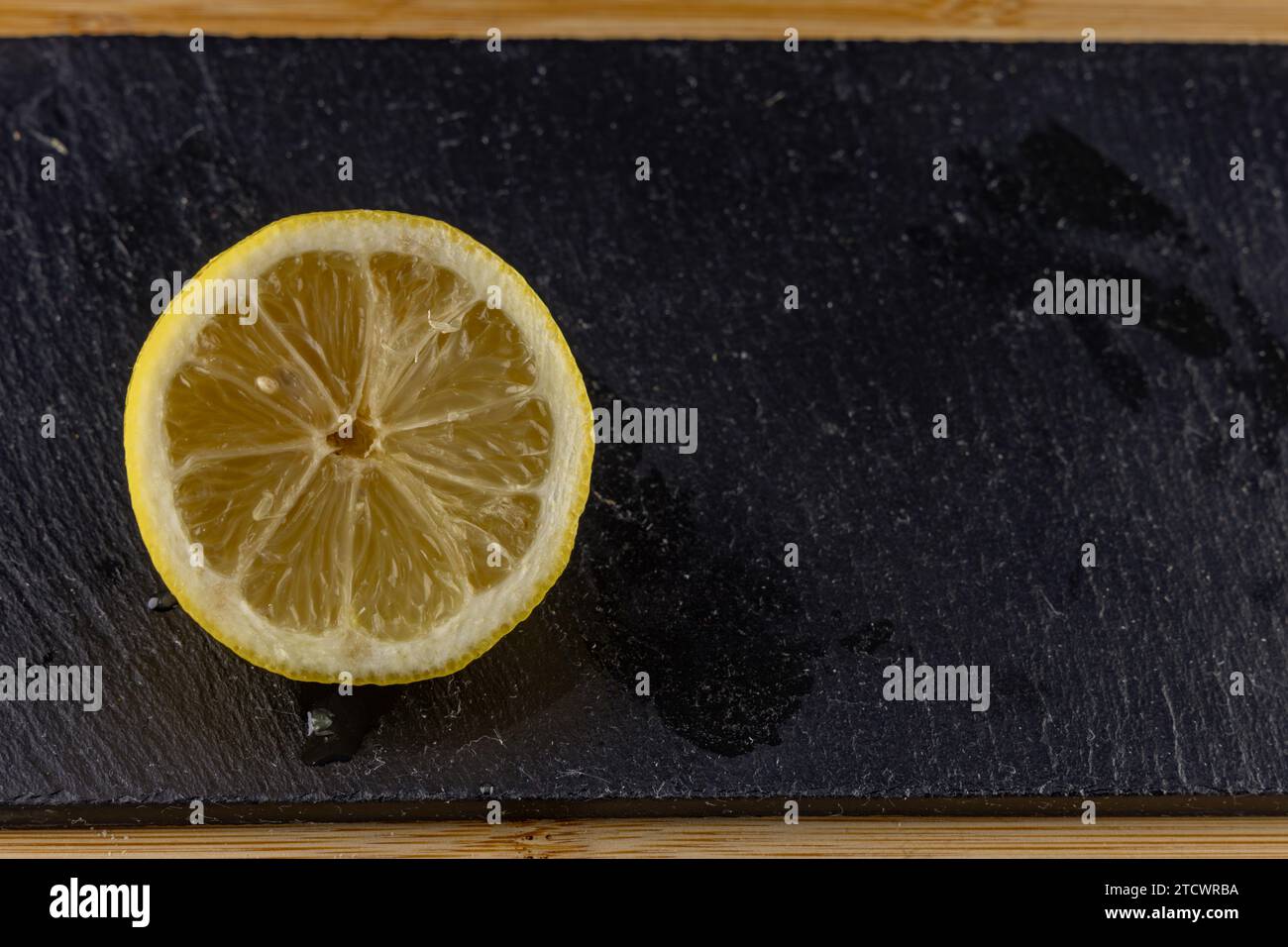 Yellow lemon cut in half on a stone slab, citrus fruits Stock Photo - Alamy
