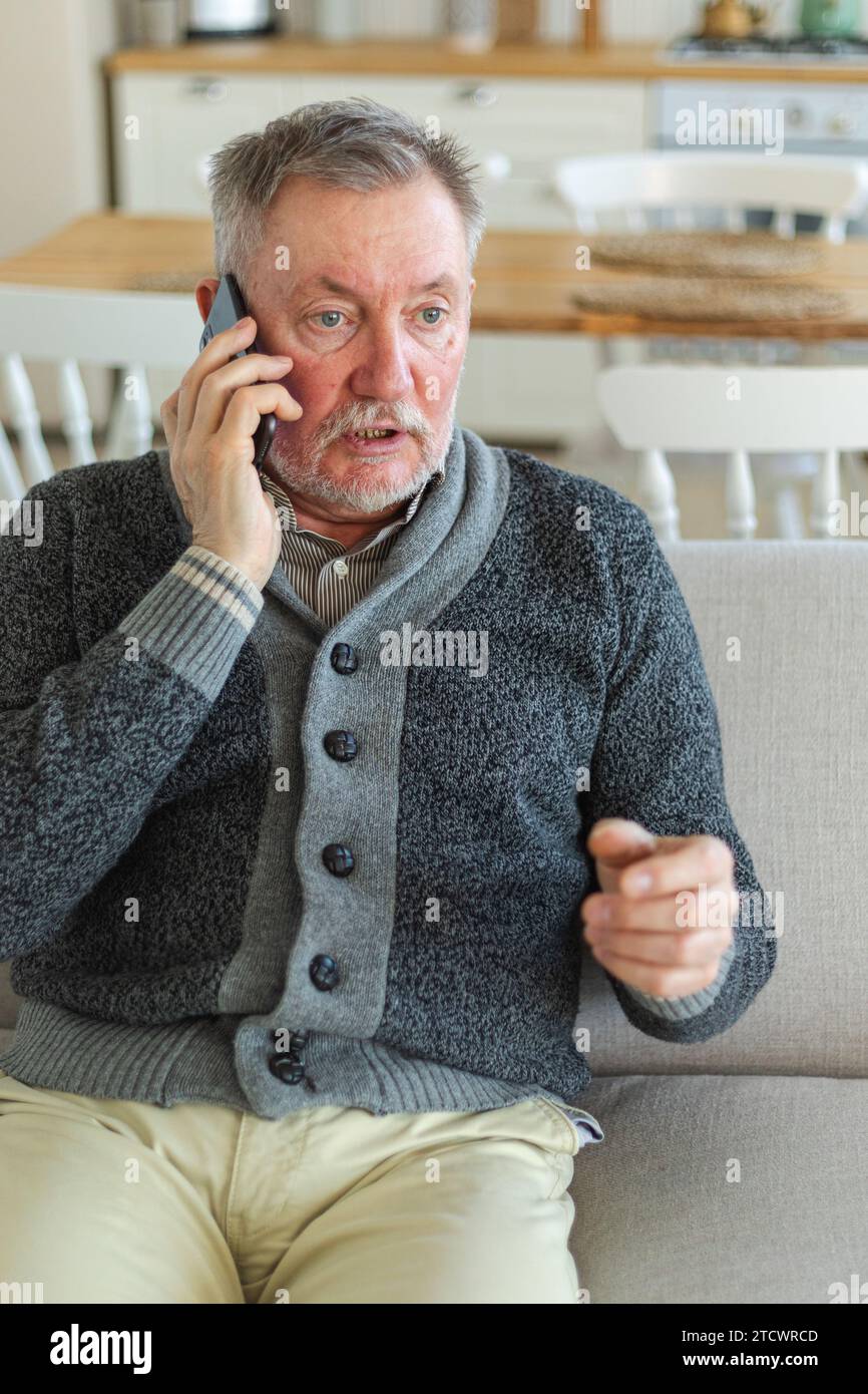Happy middle aged senior man talking on smartphone with family friends ...