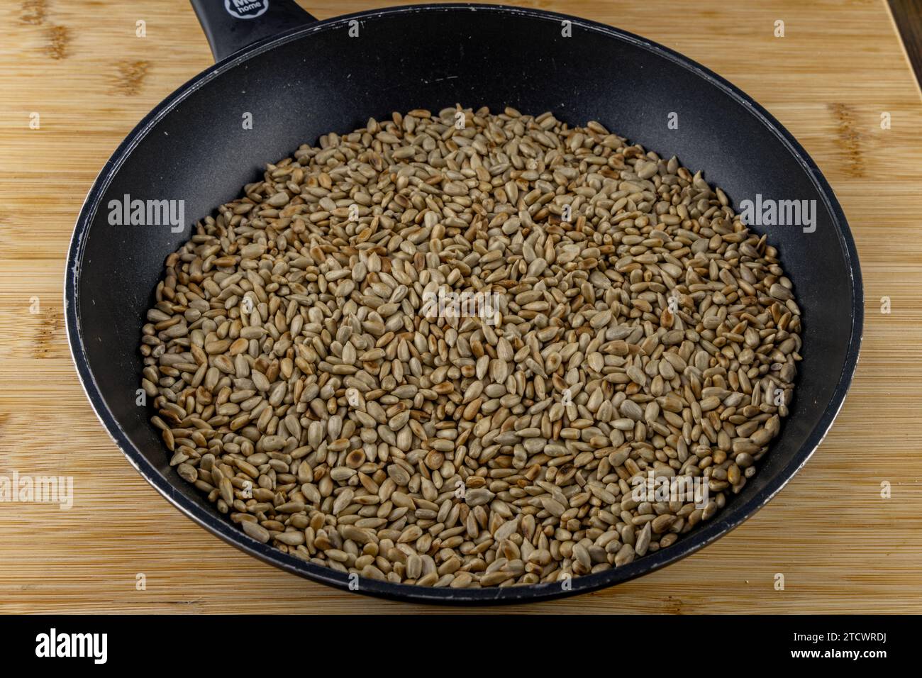 Roasted sunflower seeds in a pan, ingredients for the cake Stock Photo ...