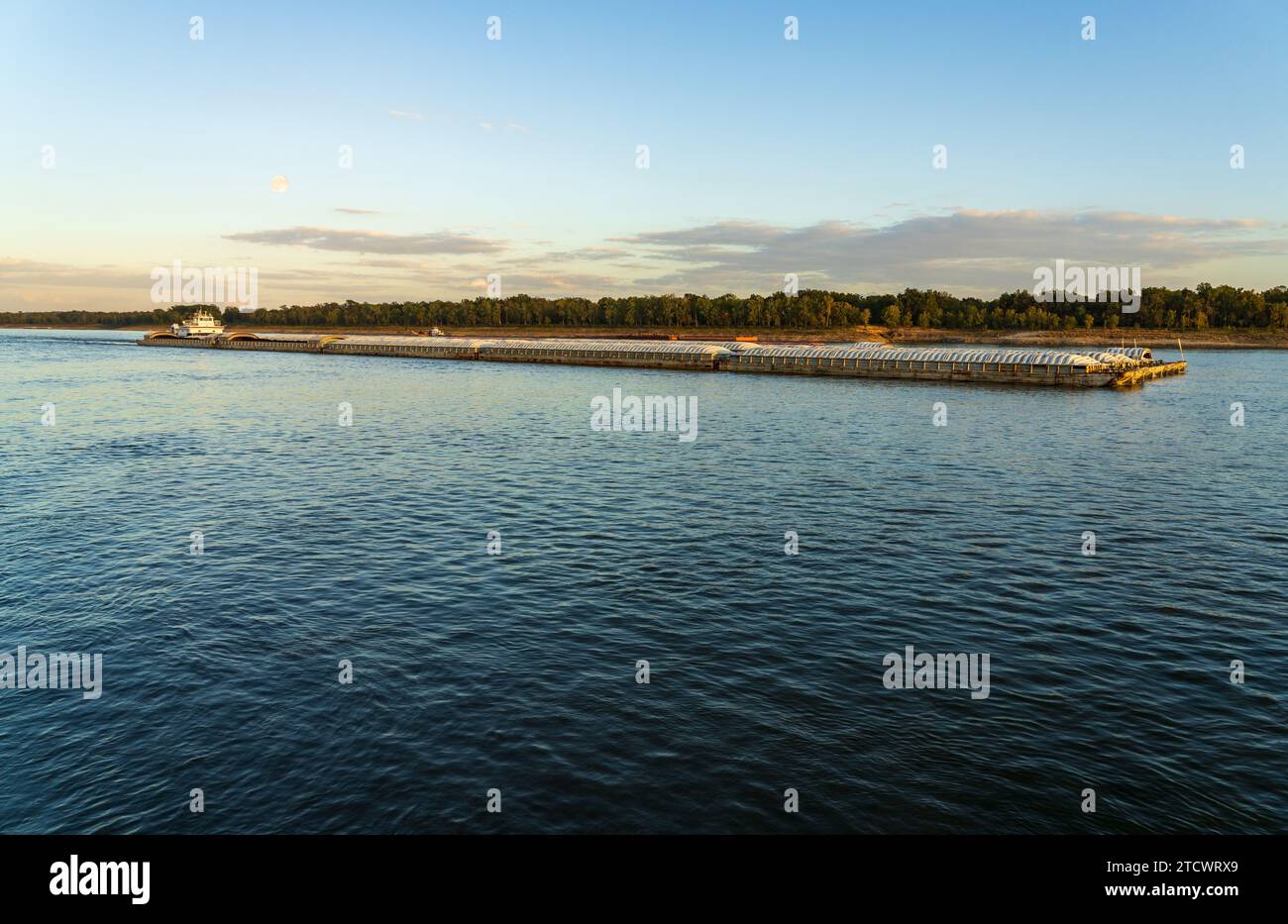 Large river barge loaded with grain sailing down Mississippi river near ...