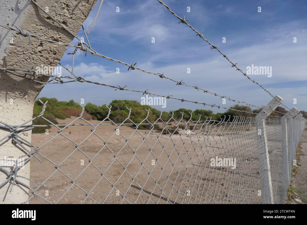 Barbed wire fence on the road. The concept of restriction of movement ...