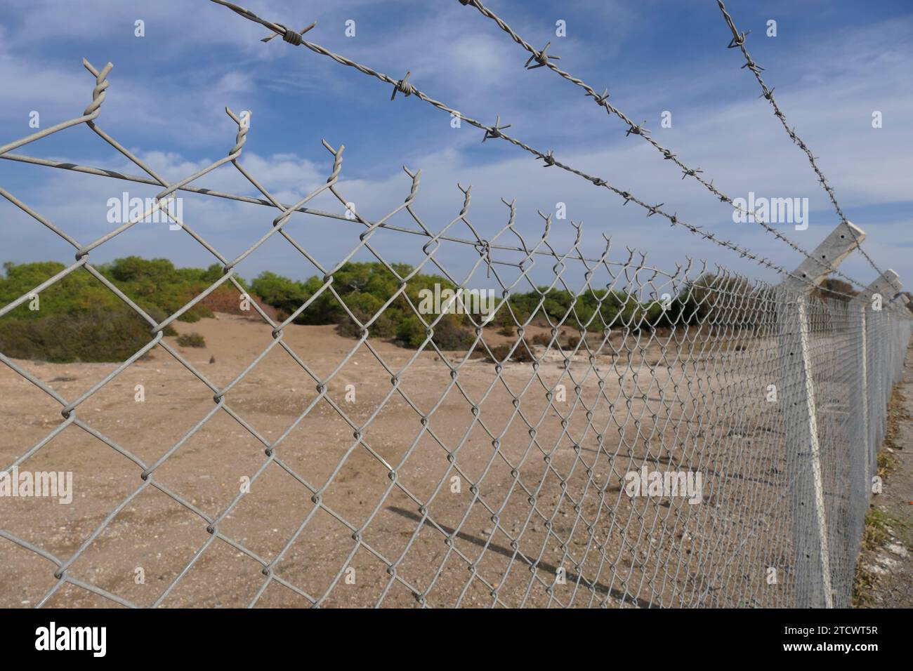 Barbed wire fence on the road. The concept of restriction of movement ...