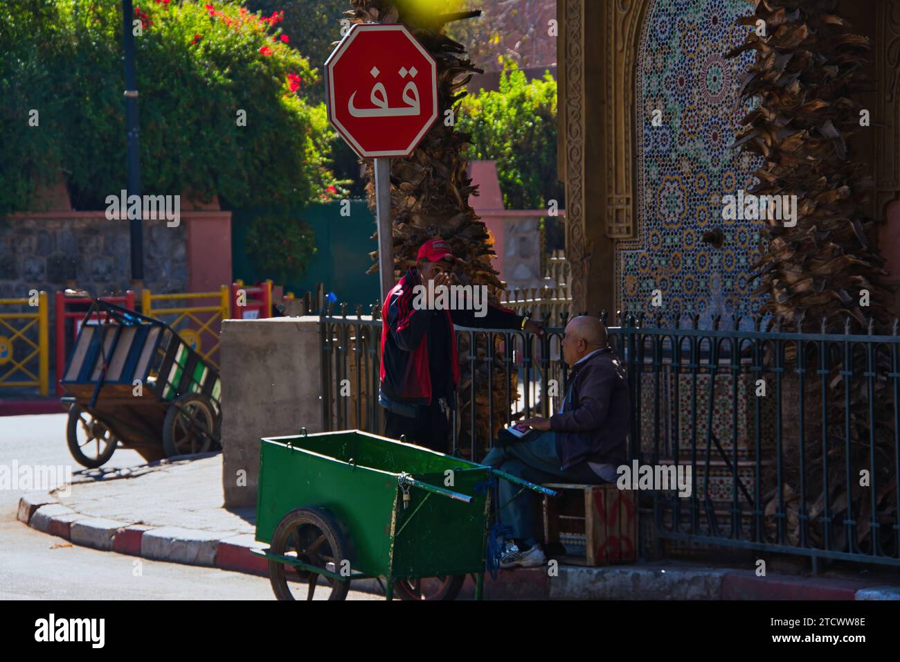 A stop for a chat with a friend on Marrakesh street Stock Photo - Alamy