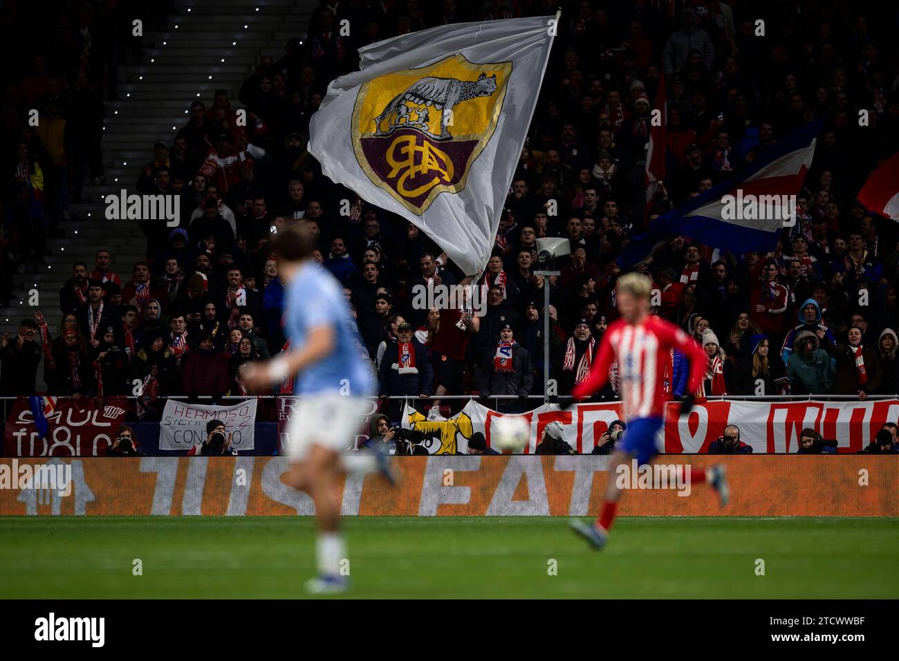Madrid, Spain. 13 December 2023. A flag of AS Roma is waved by a fan of ...