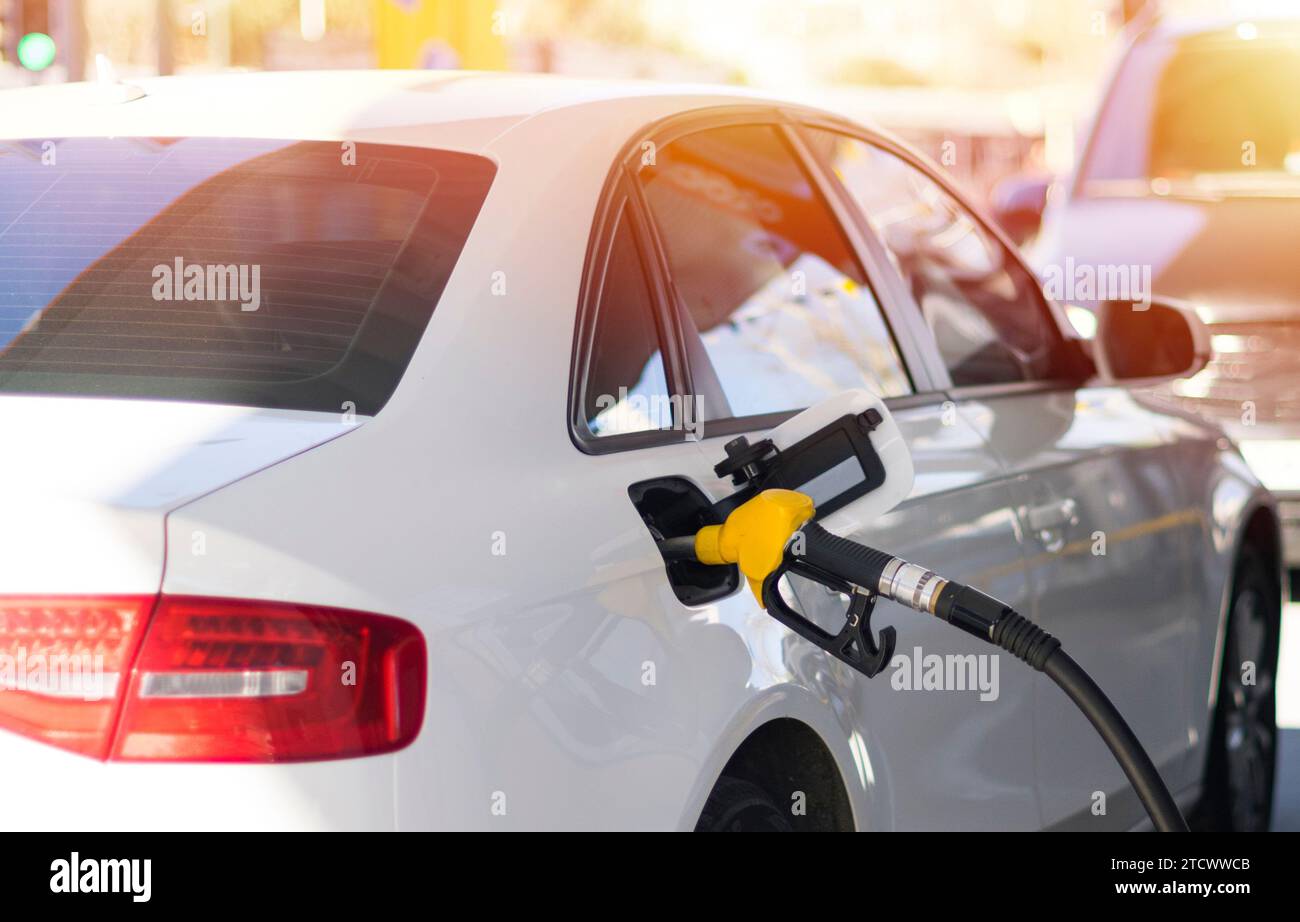 Refuel cars at the fuel pump. The driver hands, refuel and pump the car ...