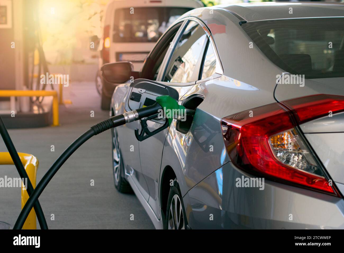 Refuel cars at the fuel pump. The driver hands, refuel and pump the car ...