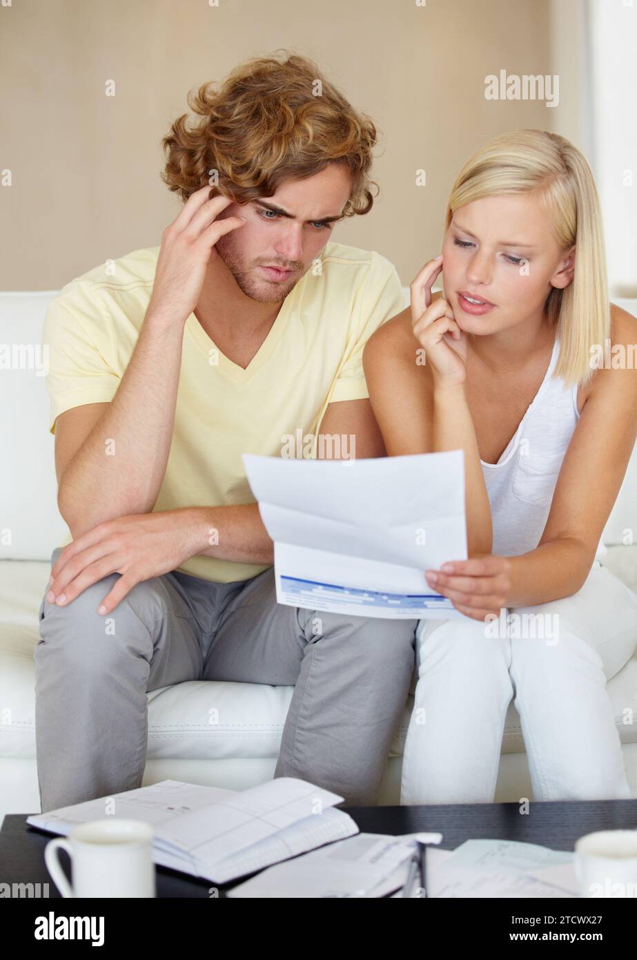 Couple, stress for bills and thinking of documents on sofa for debt ...
