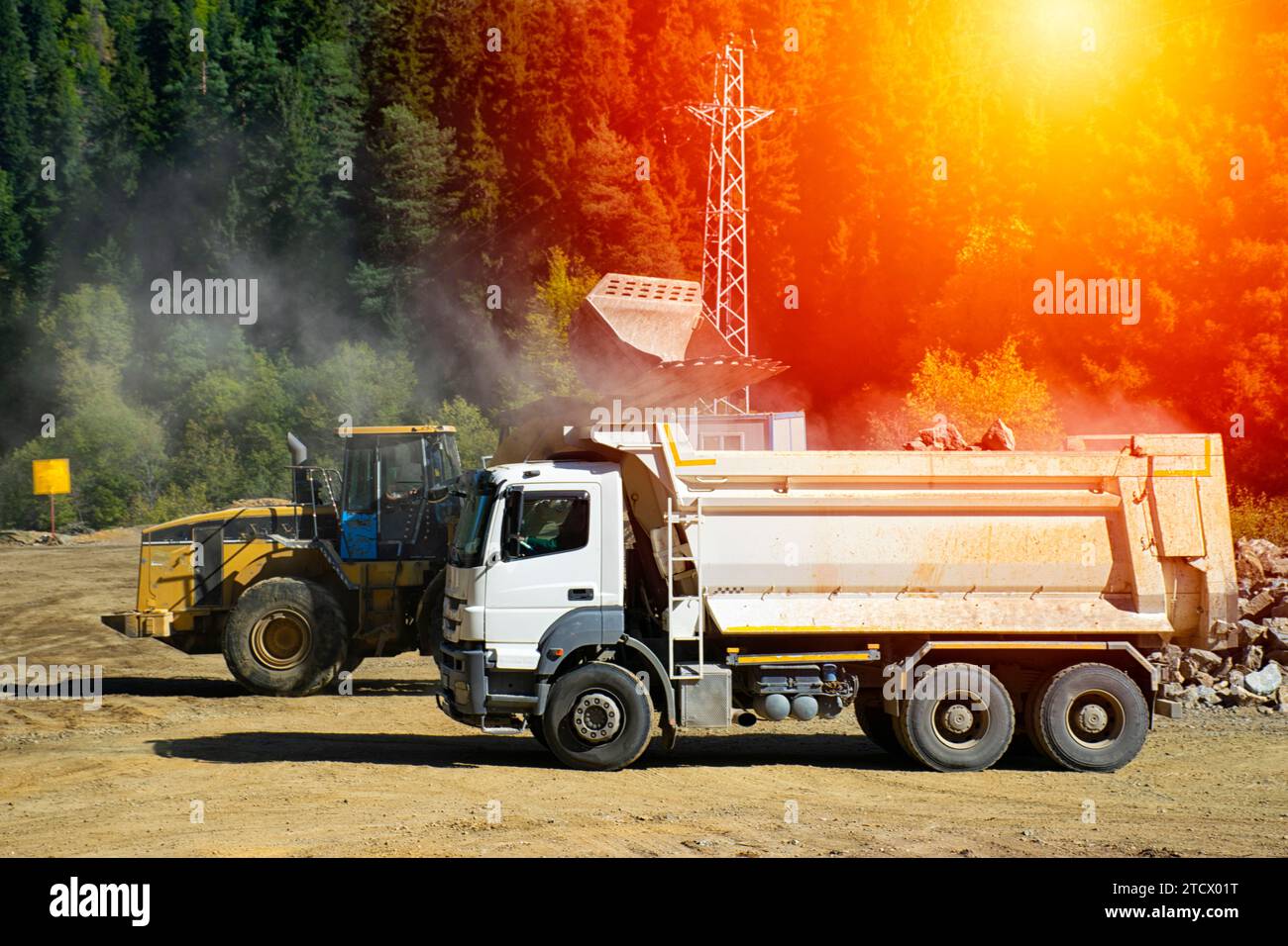 The excavator loads crushed stone in a dump truck body. Loading stones ...