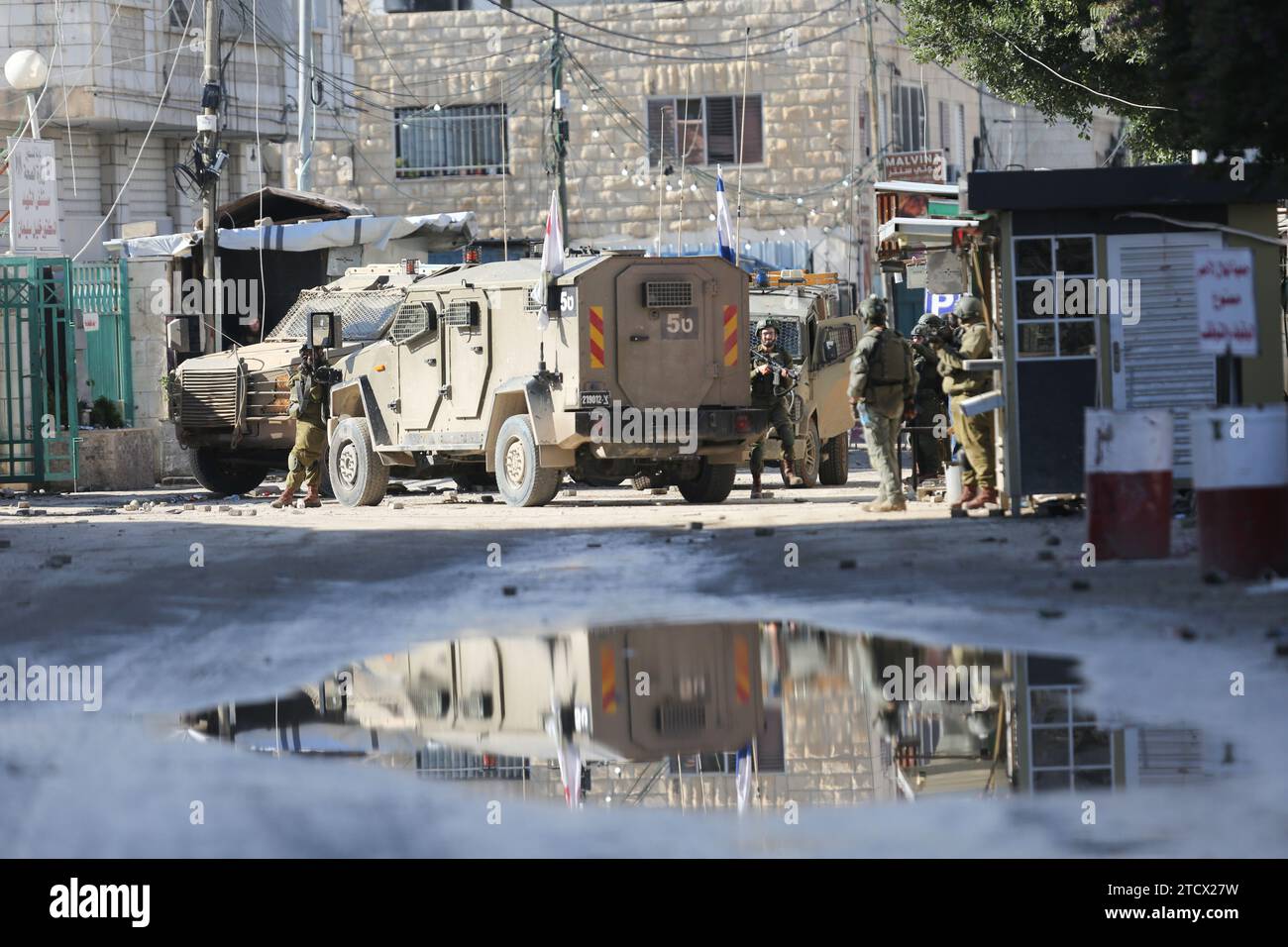Jenin, Palestine. 14th Dec, 2023. Israeli military vehicles surround ...