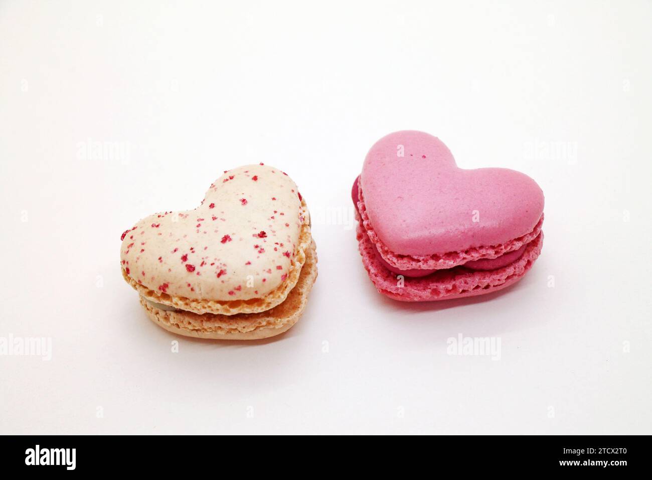 Two of heart shaped macaroons on white background close-up Stock Photo ...