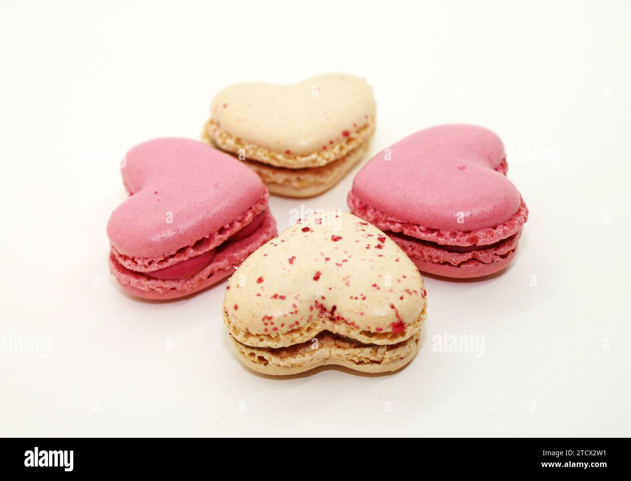 Group of heart shaped macaroons on white background Stock Photo - Alamy