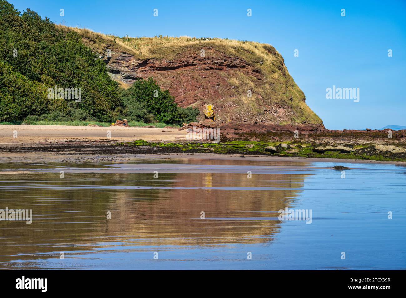 Colourful reflections of the cliffs and woodland at the west end of ...