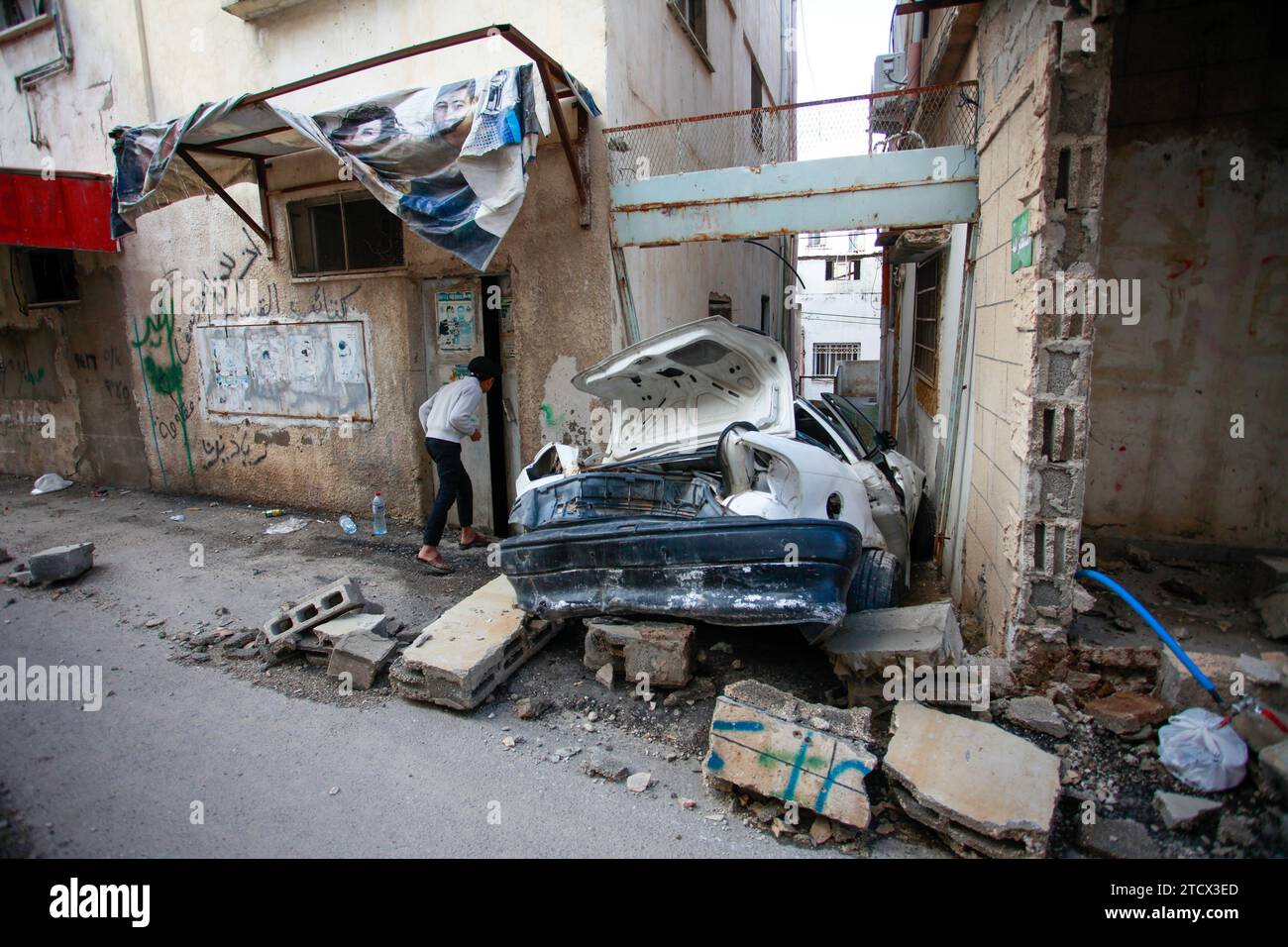 Jenin, Palestine. 14th Dec, 2023. Palestinian seen near damaged houses ...