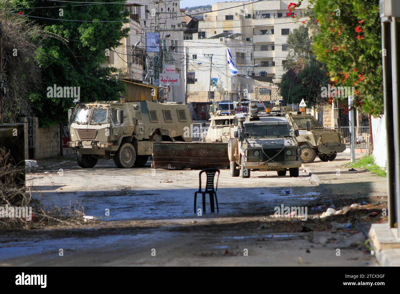 Jenin, Palestine. 14th Dec, 2023. Israeli military vehicles surround ...