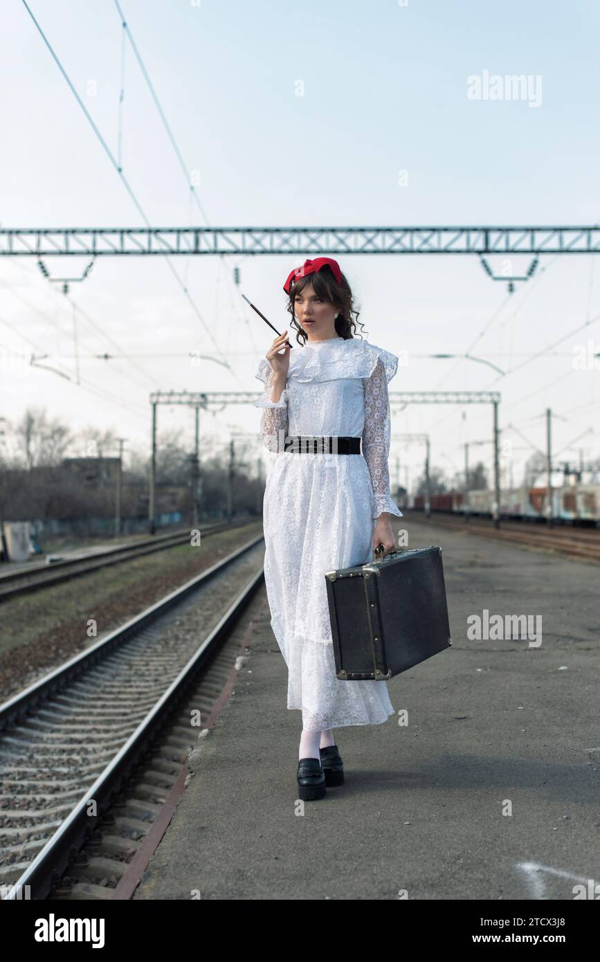 Young woman at the old train stop Stock Photo - Alamy