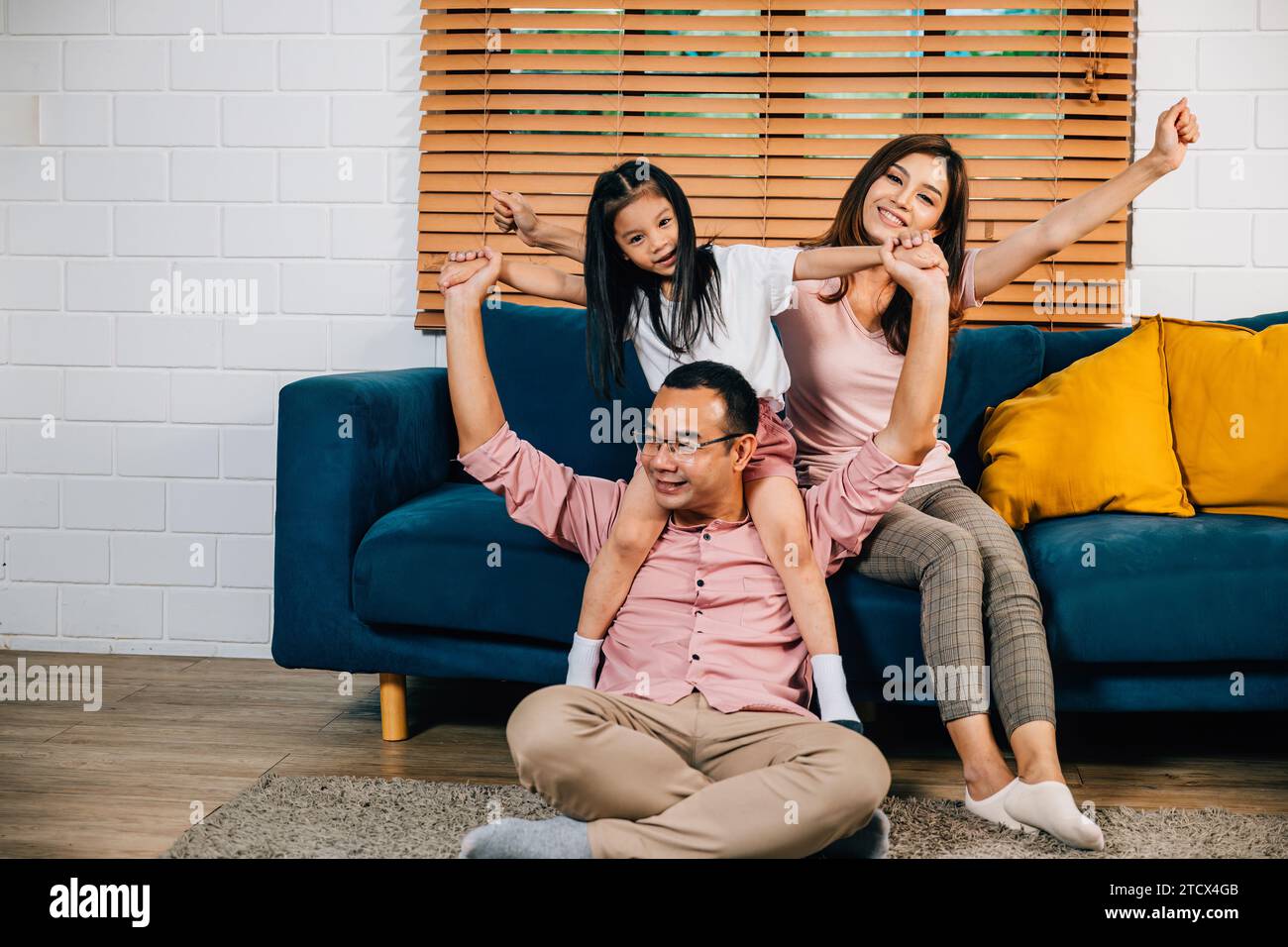 A joyful family in their comfortable modern house enjoys quality time ...