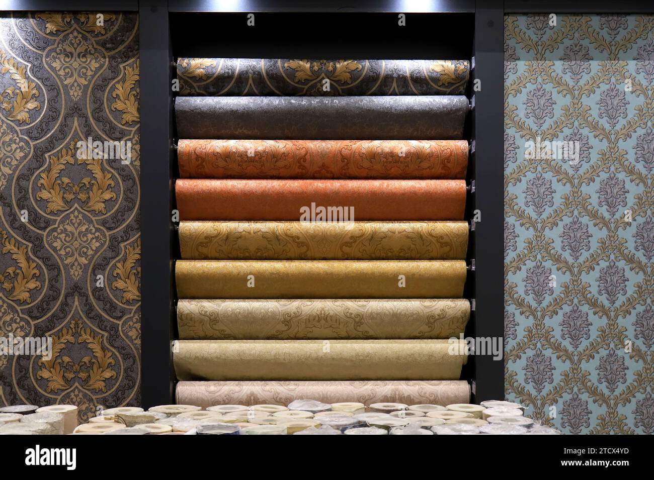 Rolls of vinyl wallpaper in building store. Various textures and colors ...