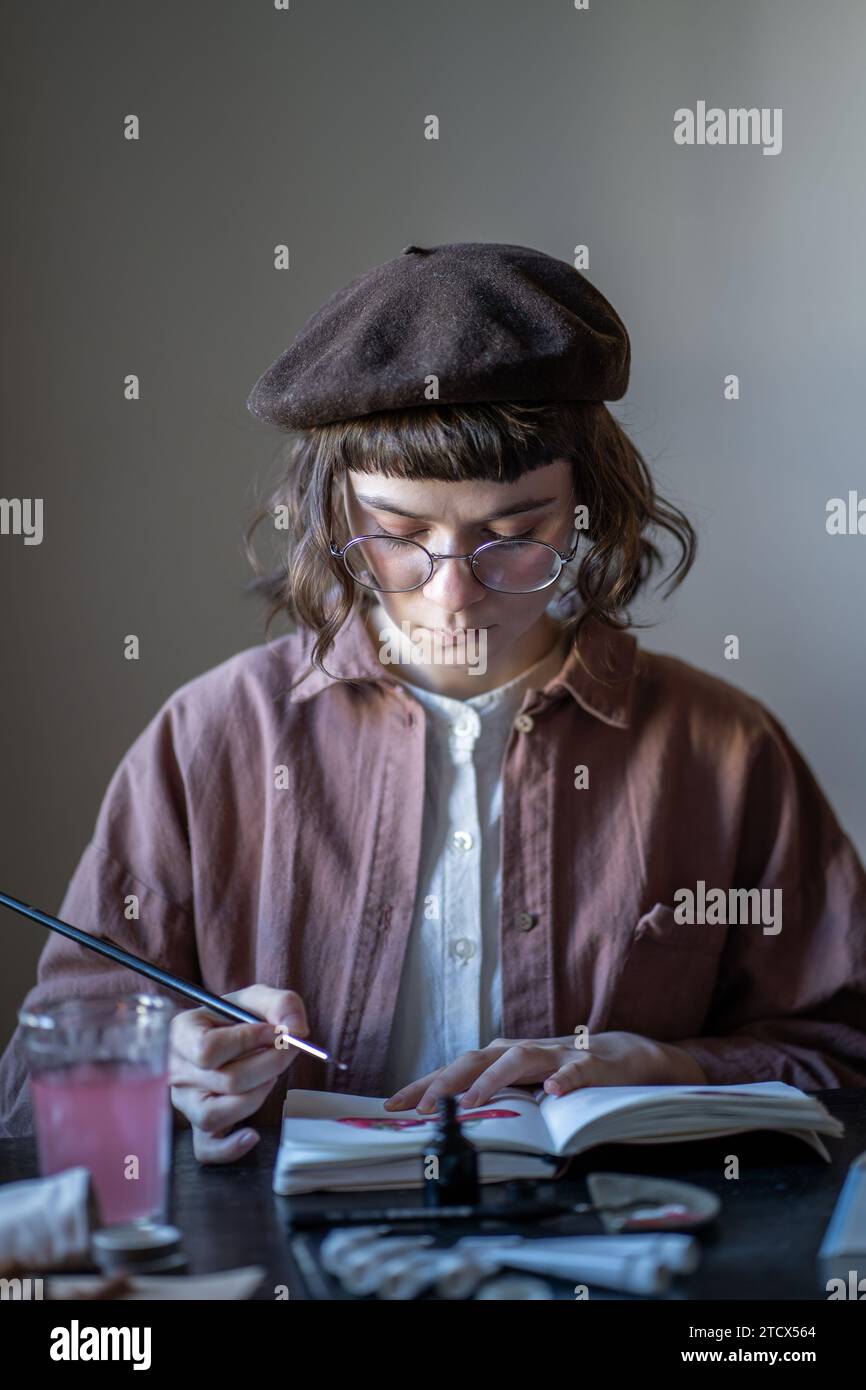 Art student designer illustrator painting sketches in sketchbook ...