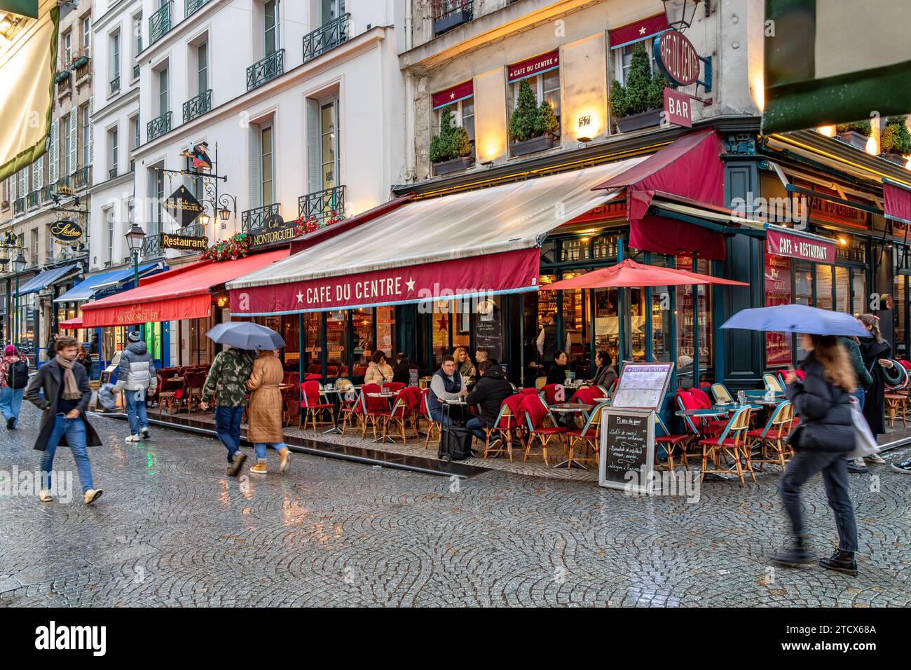 People sitting down on the outdoor terrace at Café du centre, a French ...