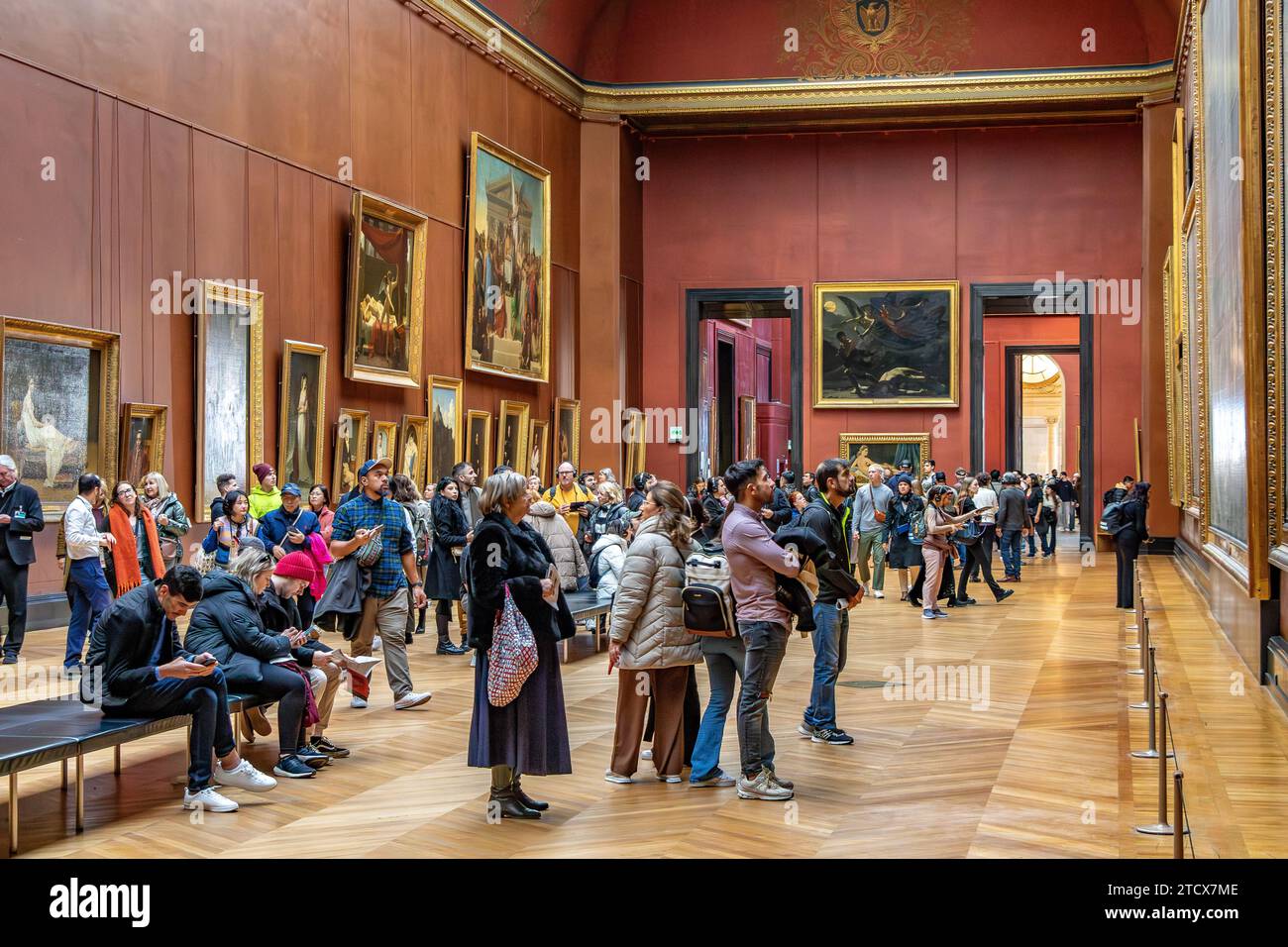 People viewing the large Frech paintings hun in The Red Rooms in Denon ...