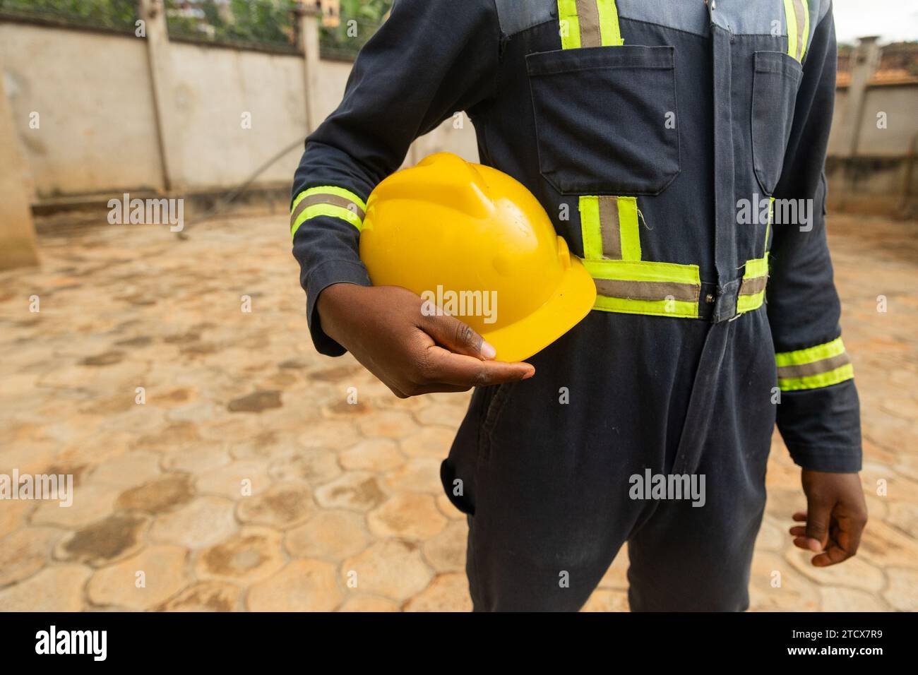 Faceless close-up of a technician dressed in his work outfit holding ...