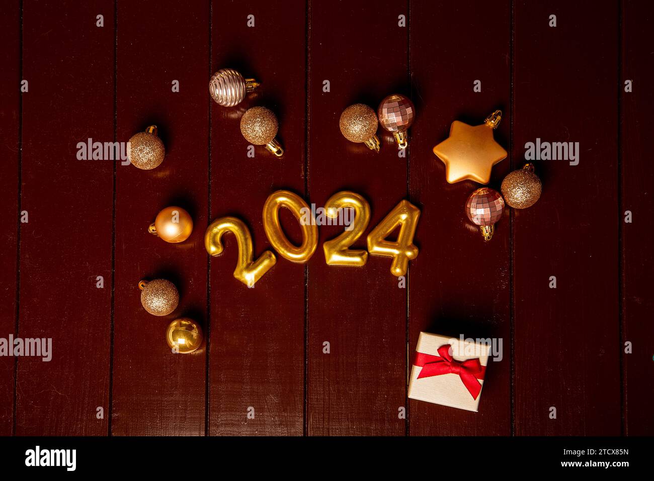 Golden numbers 2024 on wooden brown background among Christmas ...