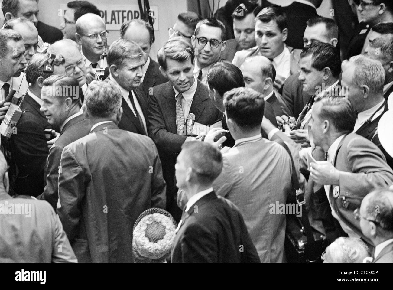 Robert F. Kennedy talking to delegates on convention floor during ...