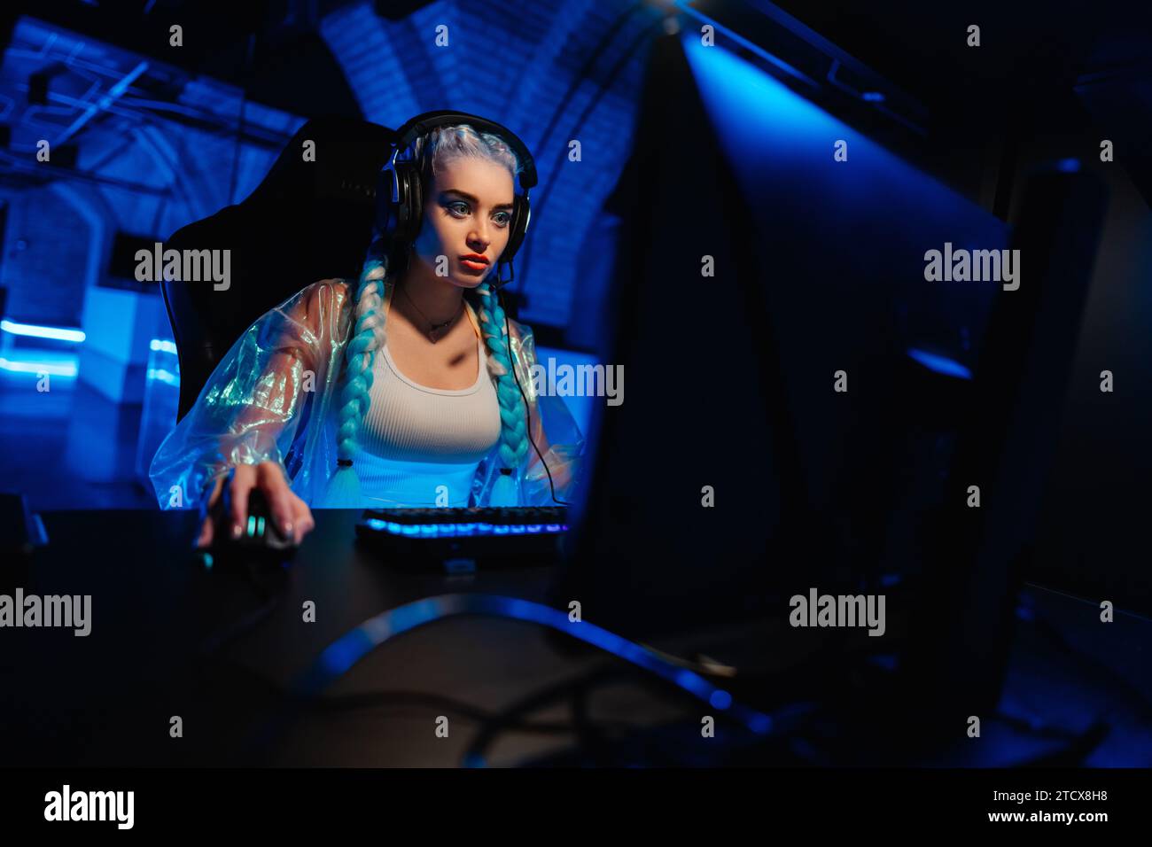 Young female cyber gamer, cosplayer plays computer games Stock Photo ...