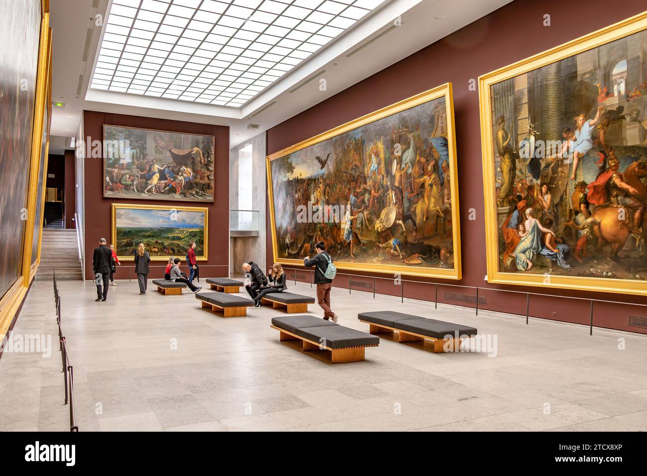 People looking at large format paintings in The Louvre Museum in Paris ...