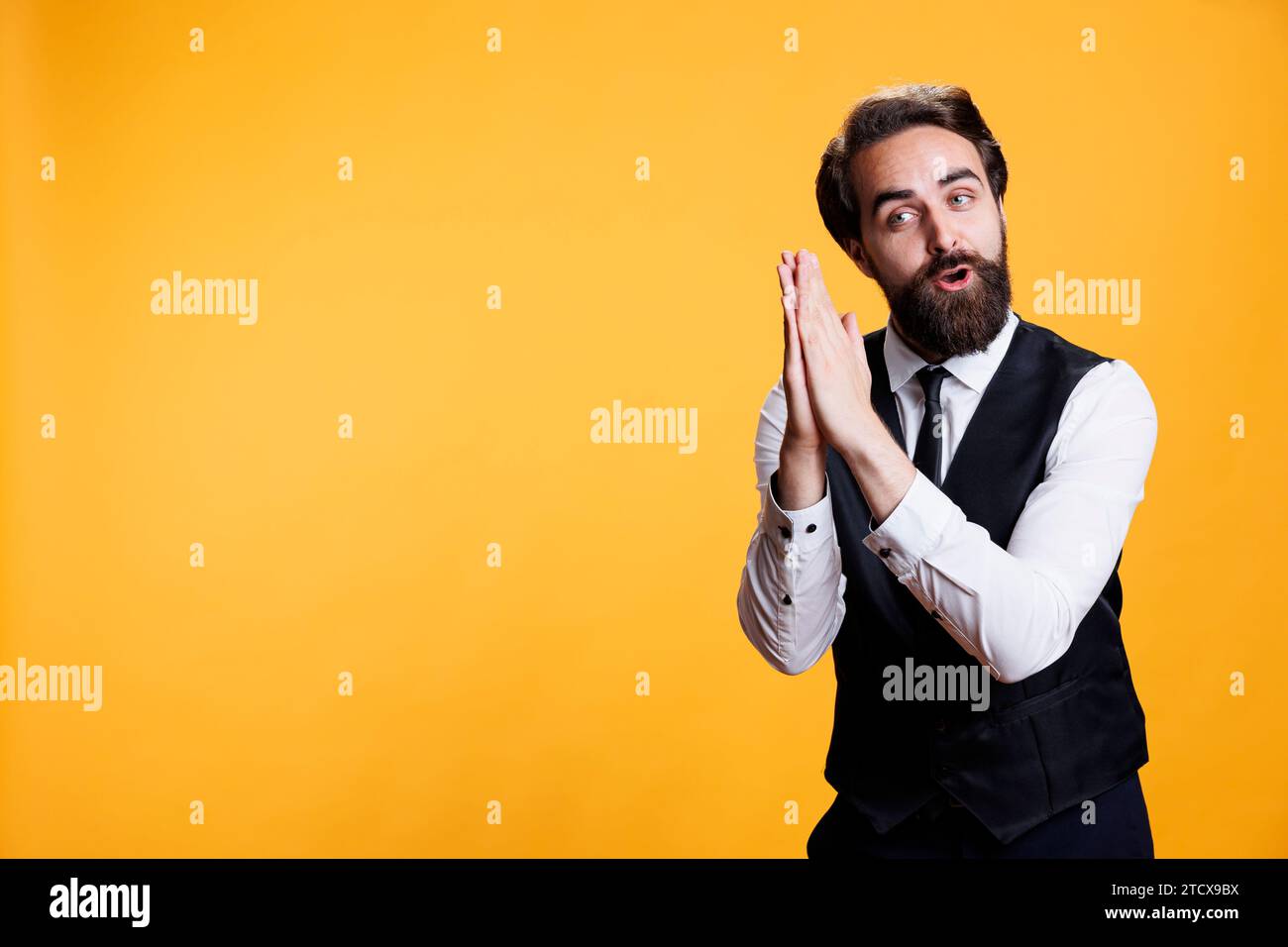 Young adult butler applauding on camera, doing standing ovation gesture ...