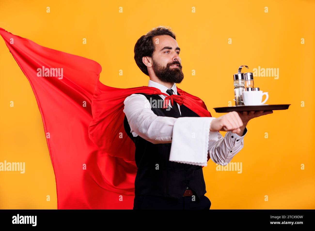 Strong waiter serves food on tray while he is wearing formal suit and ...