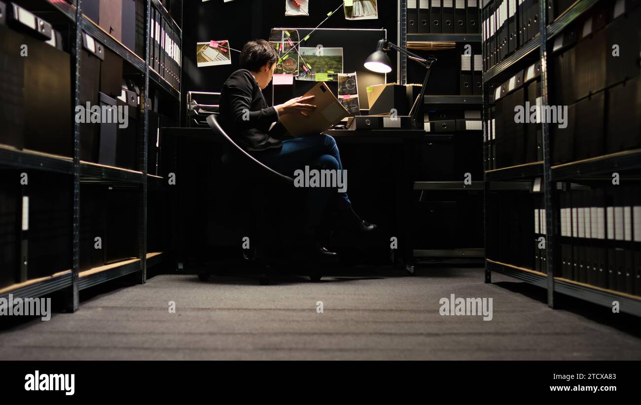 Law agent examine surveillance photos on laptop to connect the dots and ...