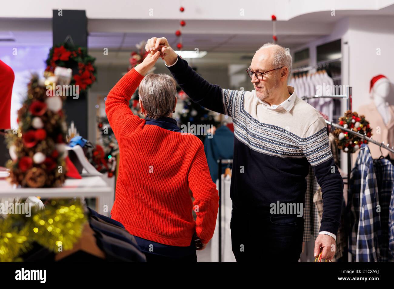 Cute couple dancing in retail store, moving around on ambience tunes ...