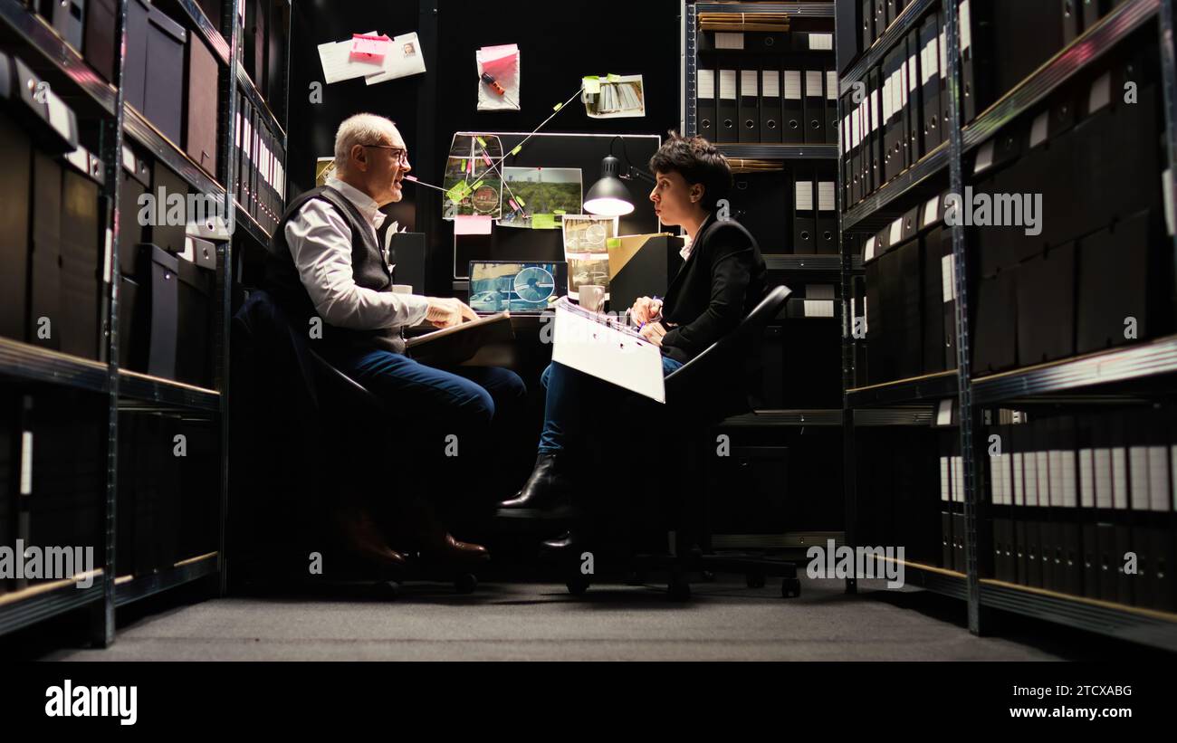 Private investigators on police duty, comparing surveillance photos and ...