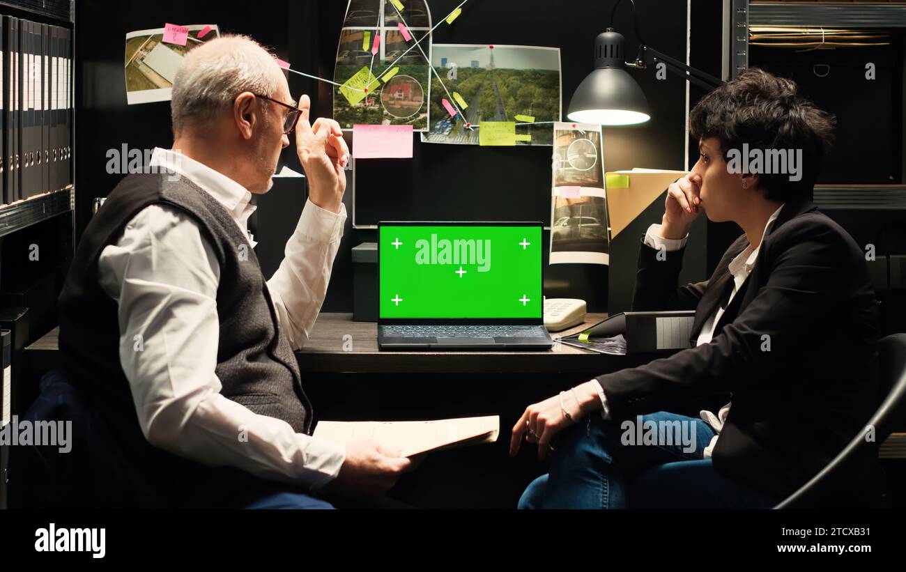 Police team using greenscreen display, working on criminal ...