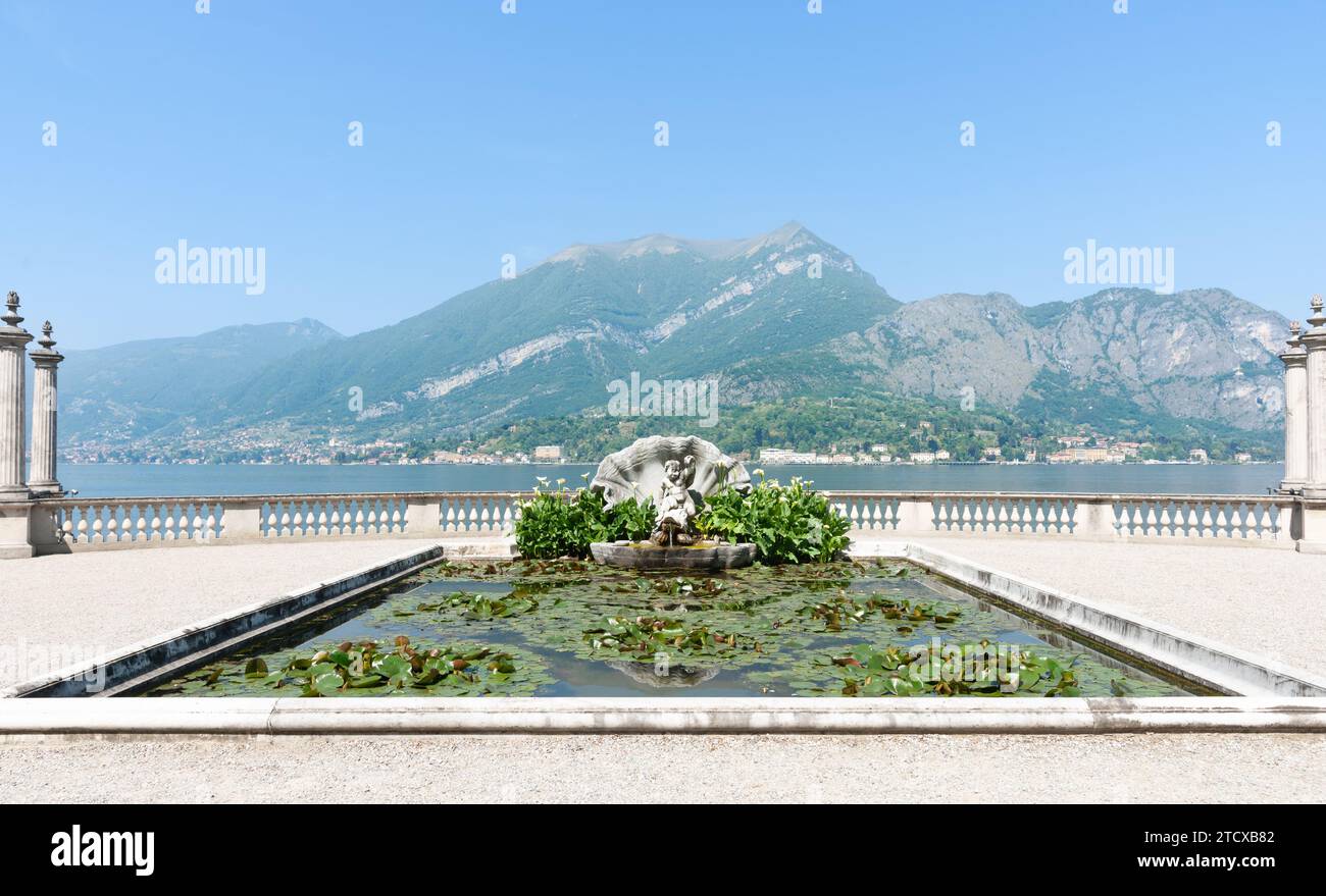 Pond of water lily and scenic mountains beyond Lake Como Italy Stock ...