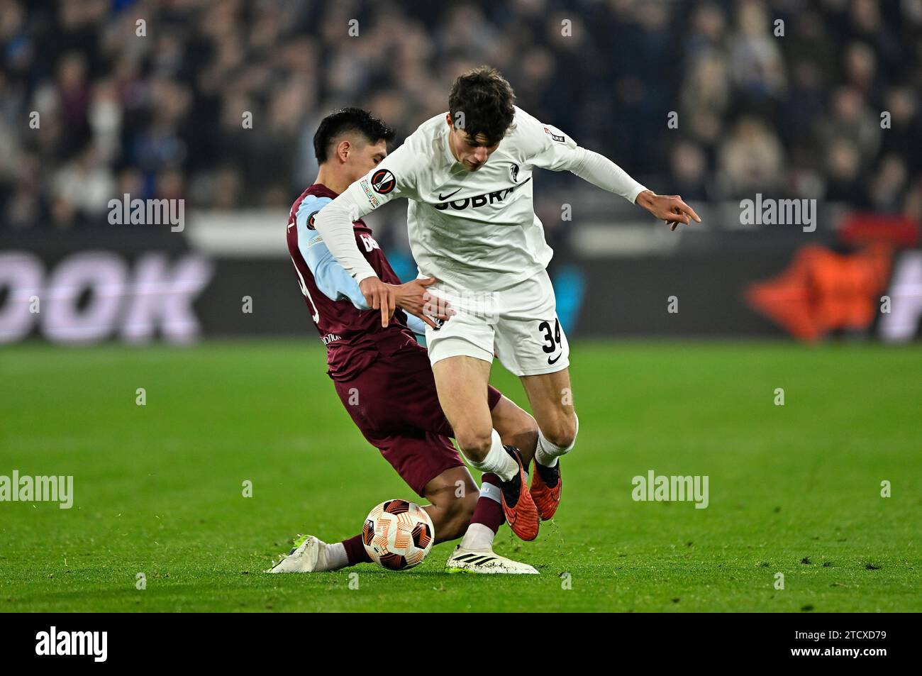 London, UK. 14th Dec, 2023. Merlin Röhl (SC Freiburg) is tackled by ...