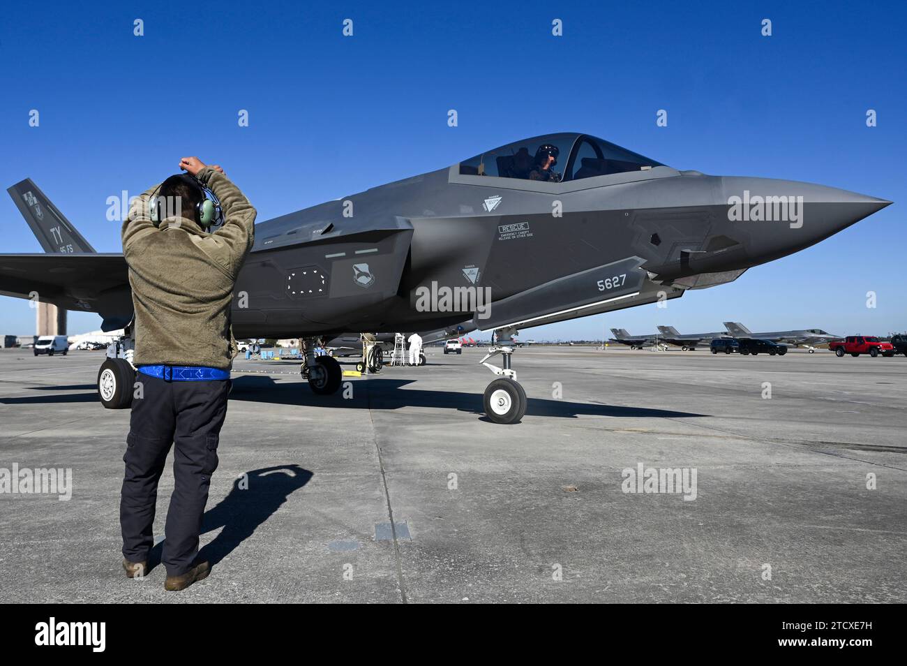 A U.S. Air Force maintainer signals to an F-35 Lightning II pilot to ...
