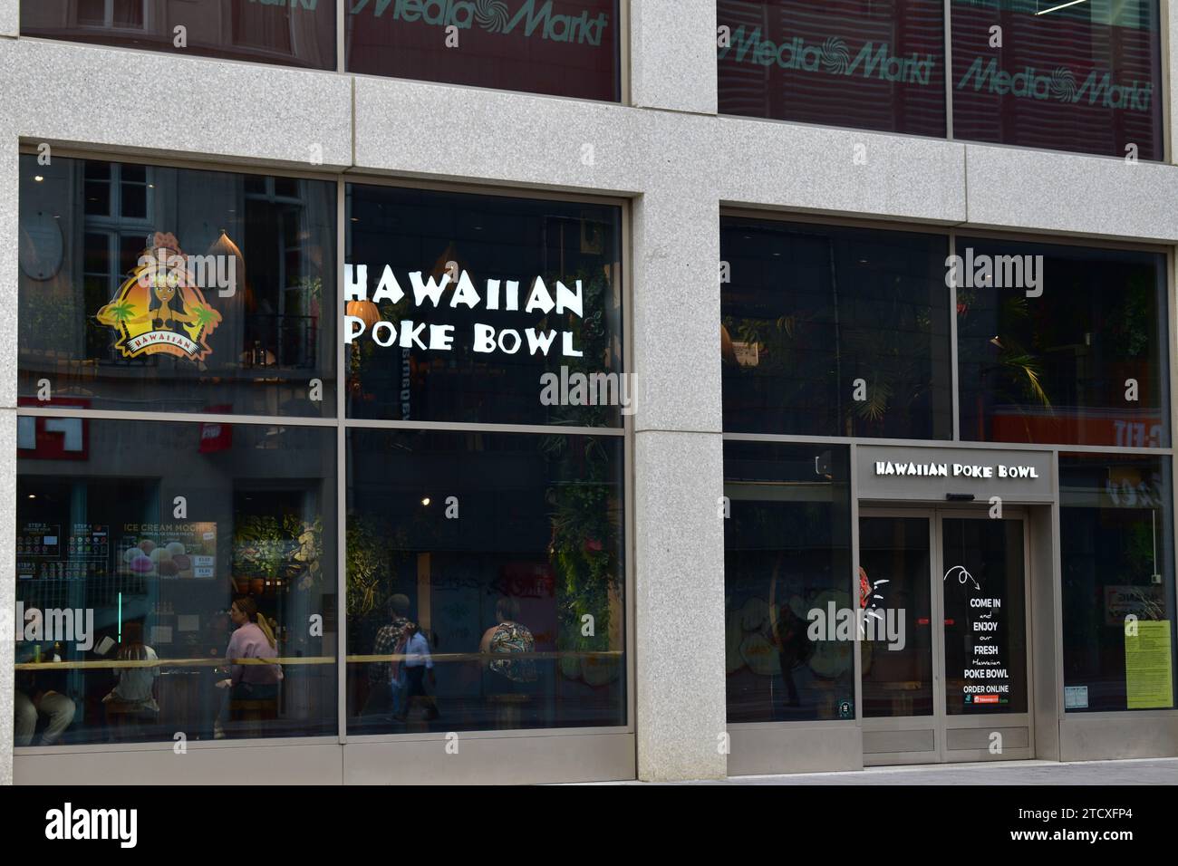 Large windows on the building which houses "Hawaiian Poke Bowl ...
