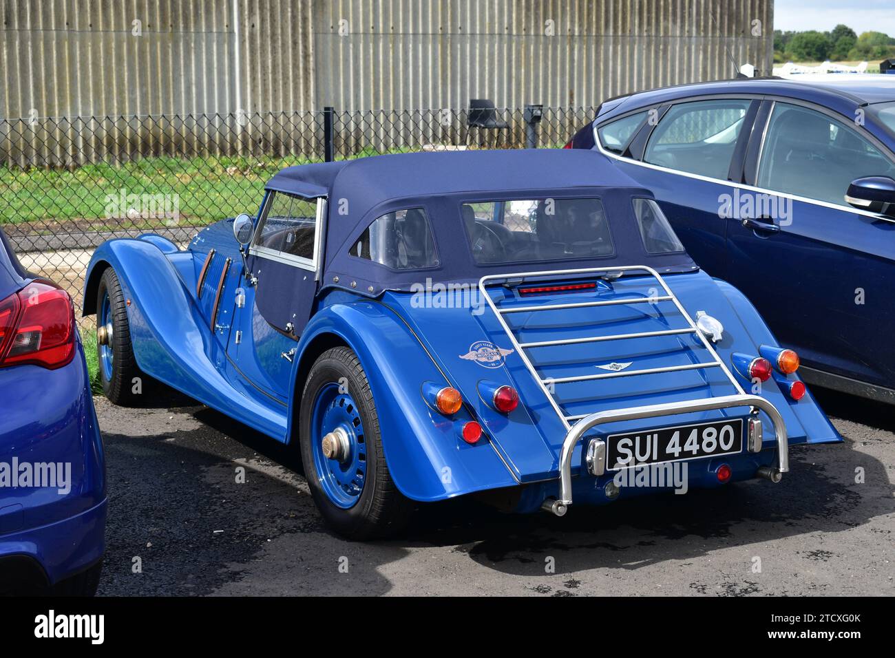 Rear view of a blue custom Morgan Plus Four vintage car parked at White ...