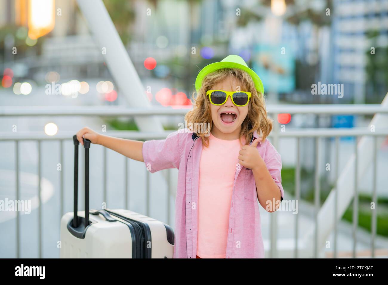 Little businessman on business trip walking with his luggage on street ...