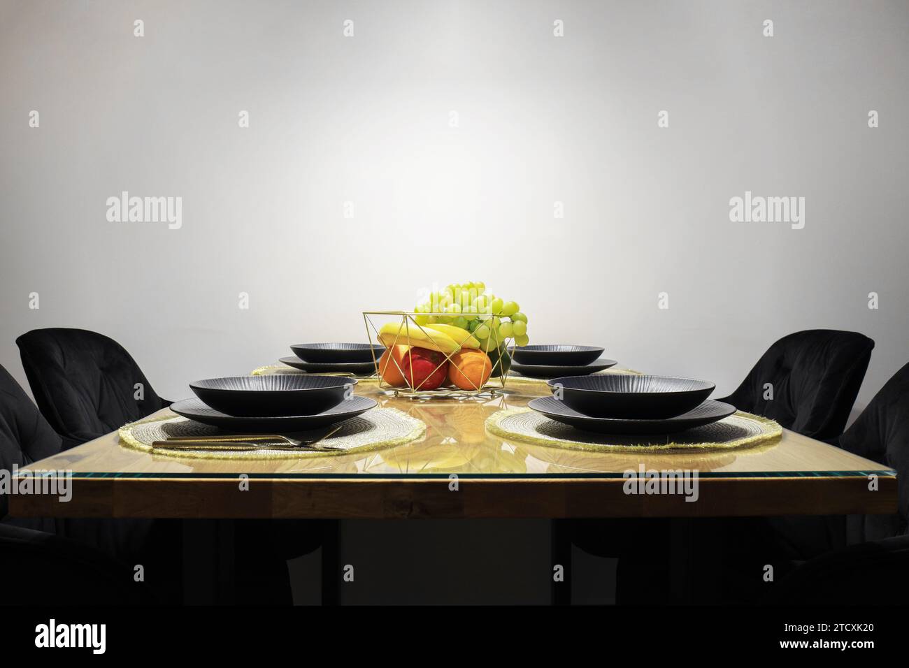 Table set for dinner near white wall Stock Photo - Alamy