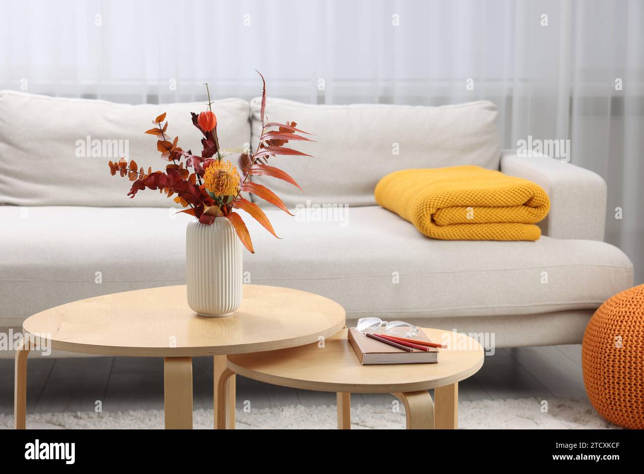 Nesting tables and comfortable sofa in living room. Interior design ...