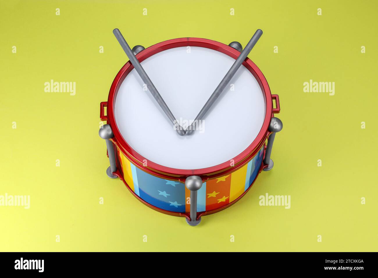 Colorful drum and sticks on light green background. Percussion musical ...