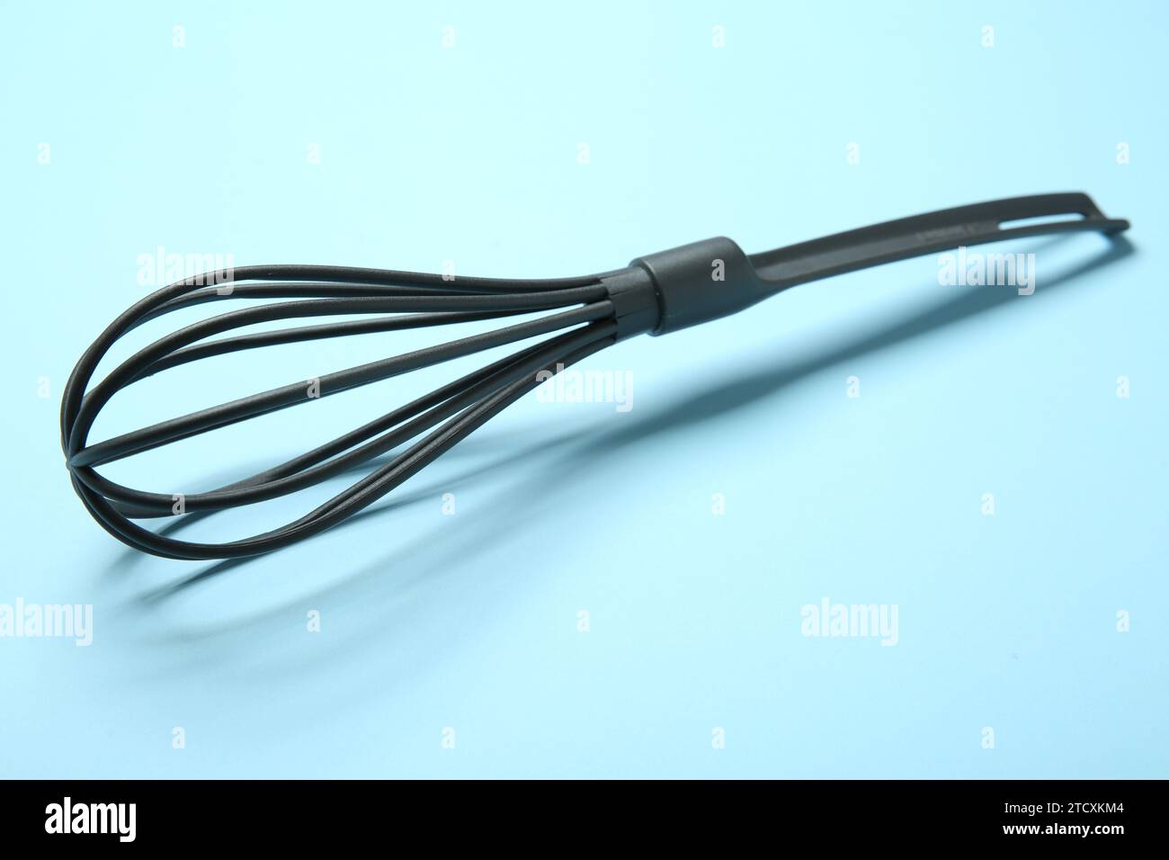 One whisk on light blue background, closeup Stock Photo - Alamy